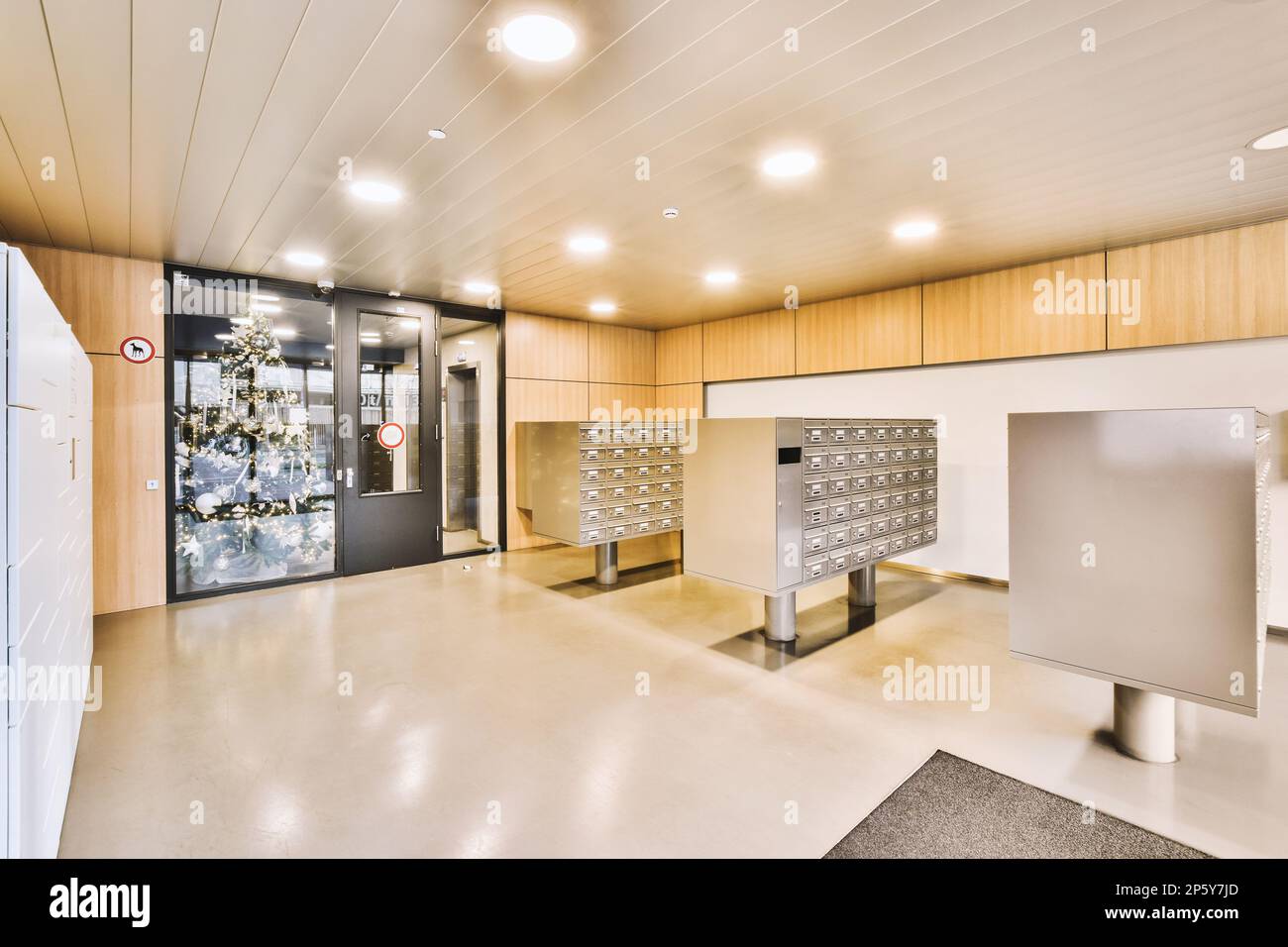 the inside of a building with many mailboxs on each side and an open ...