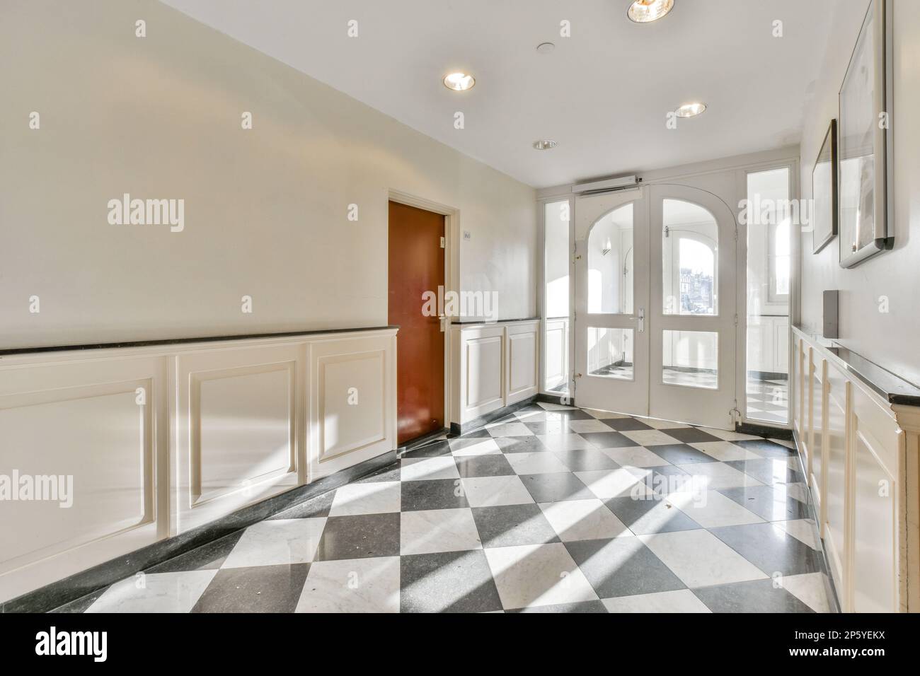 an empty room with black and white checkered tiles on the floor in this ...