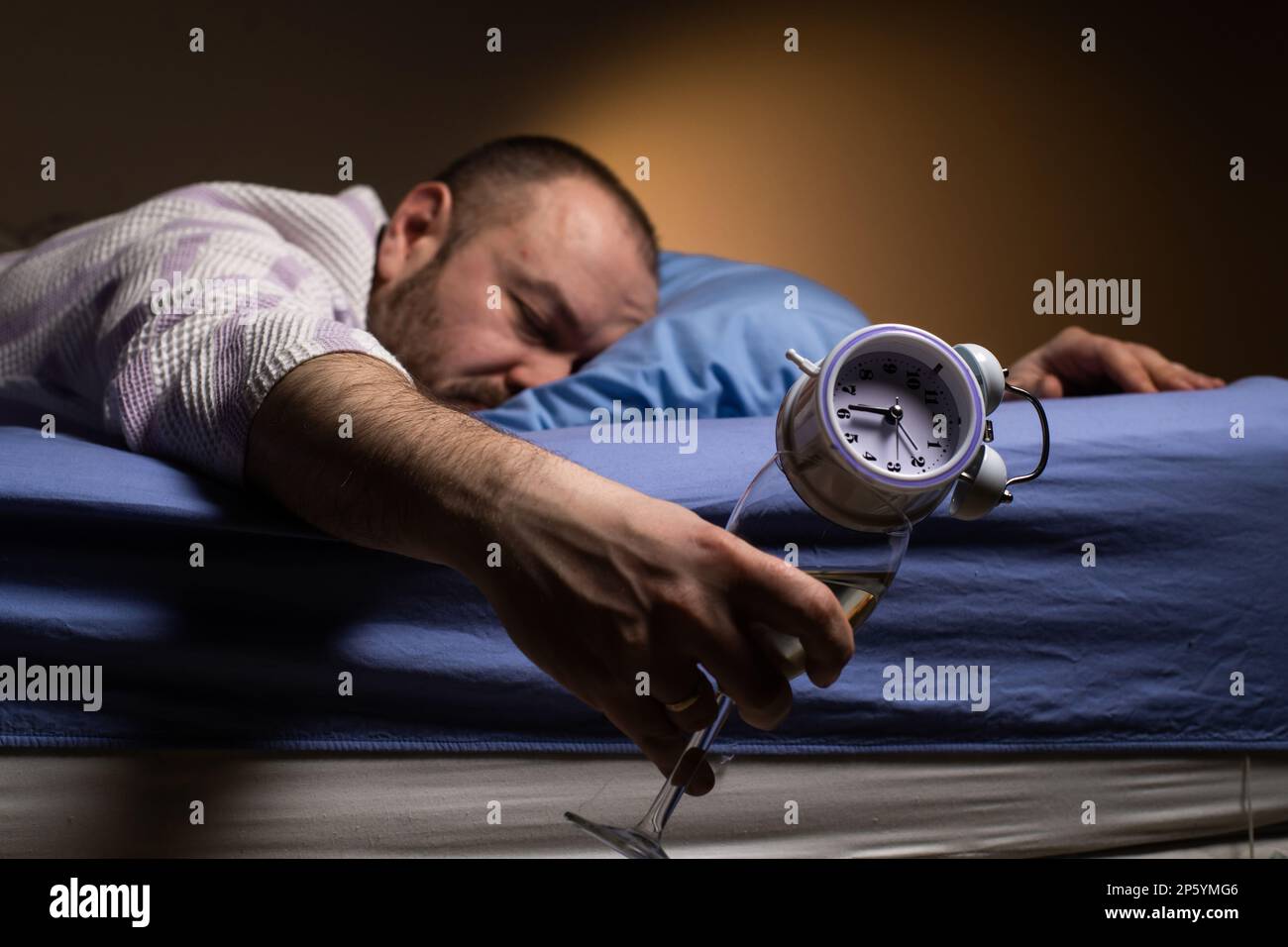 Man and alcoholism. Get drunk with alcohol and oversleep the alarm ...
