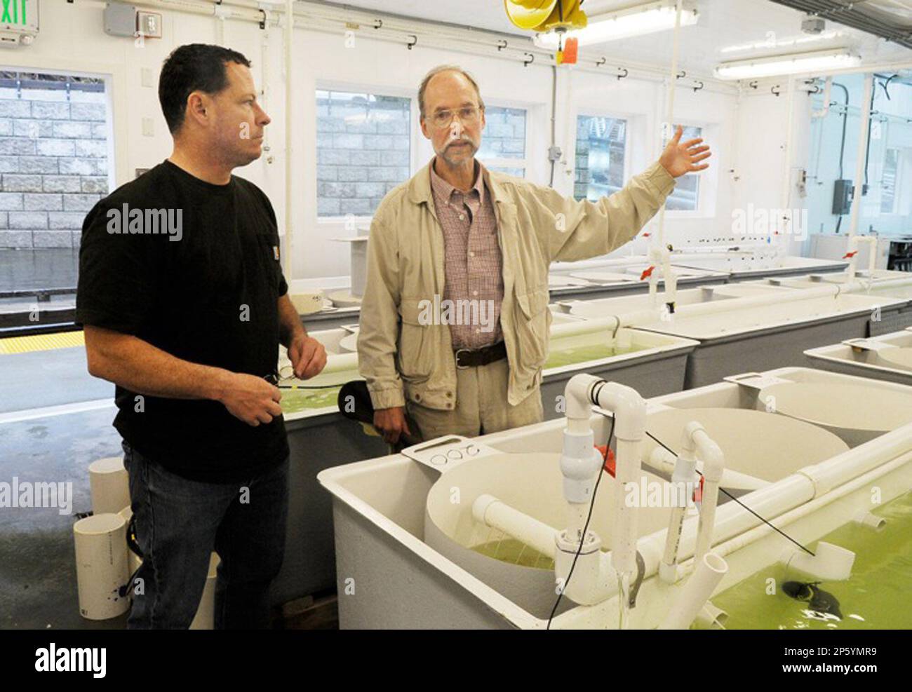 In this June 28, 2012 photo, Dave Shupert, left, shellfish biologist ...