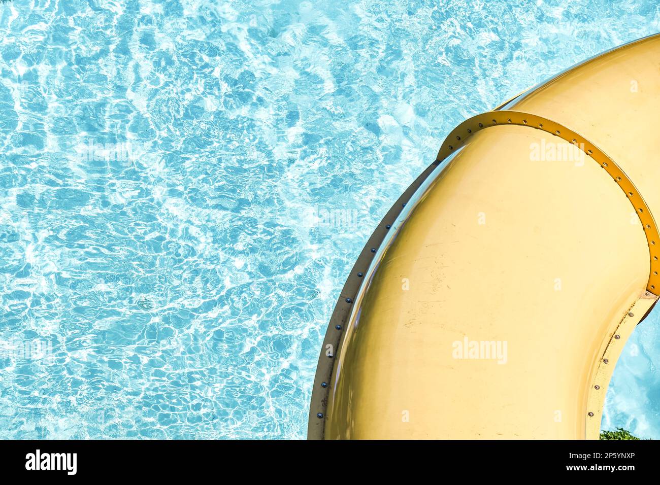Water park slide pipe against blue clear water close up. Fun ...