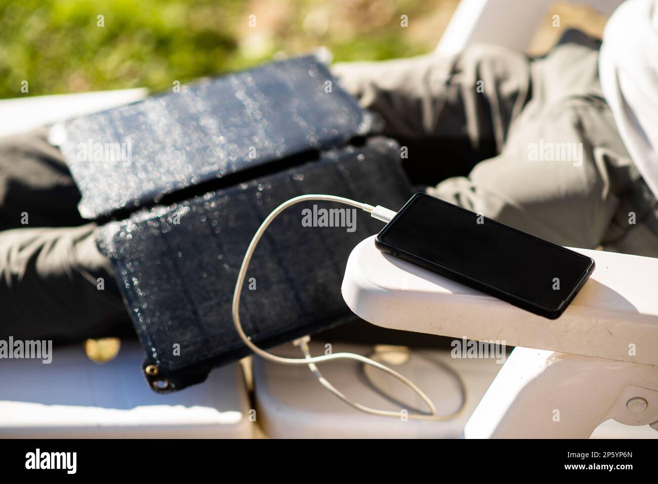 The mobile phone is charged by a solar battery. Solar battery on the ...
