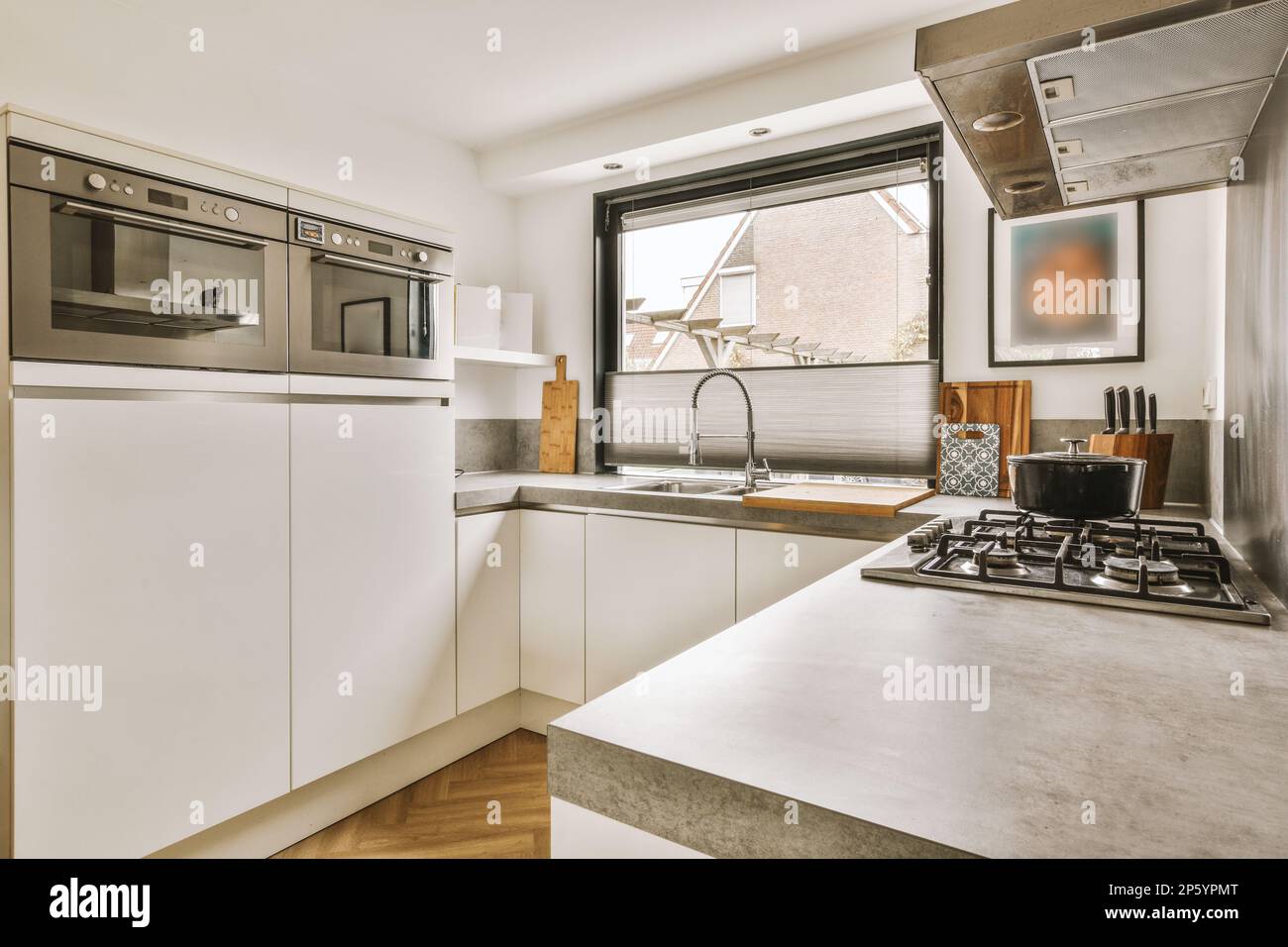 a kitchen with an oven, sink and stove in the photo is taken from the ...