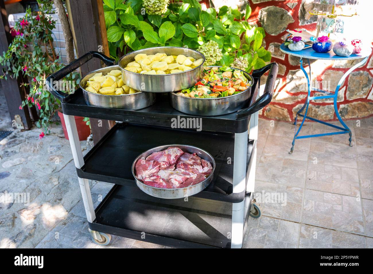 Meat and side dishes on trolley ready for cooking in restaurant ...