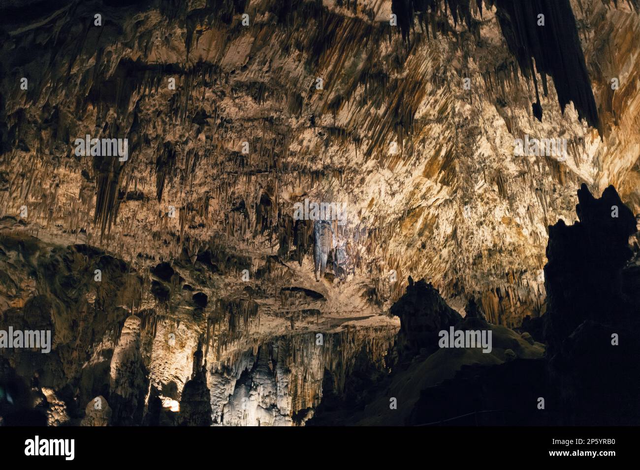 Illuminated dropstones, stalactite mineral formation that hangs from ...