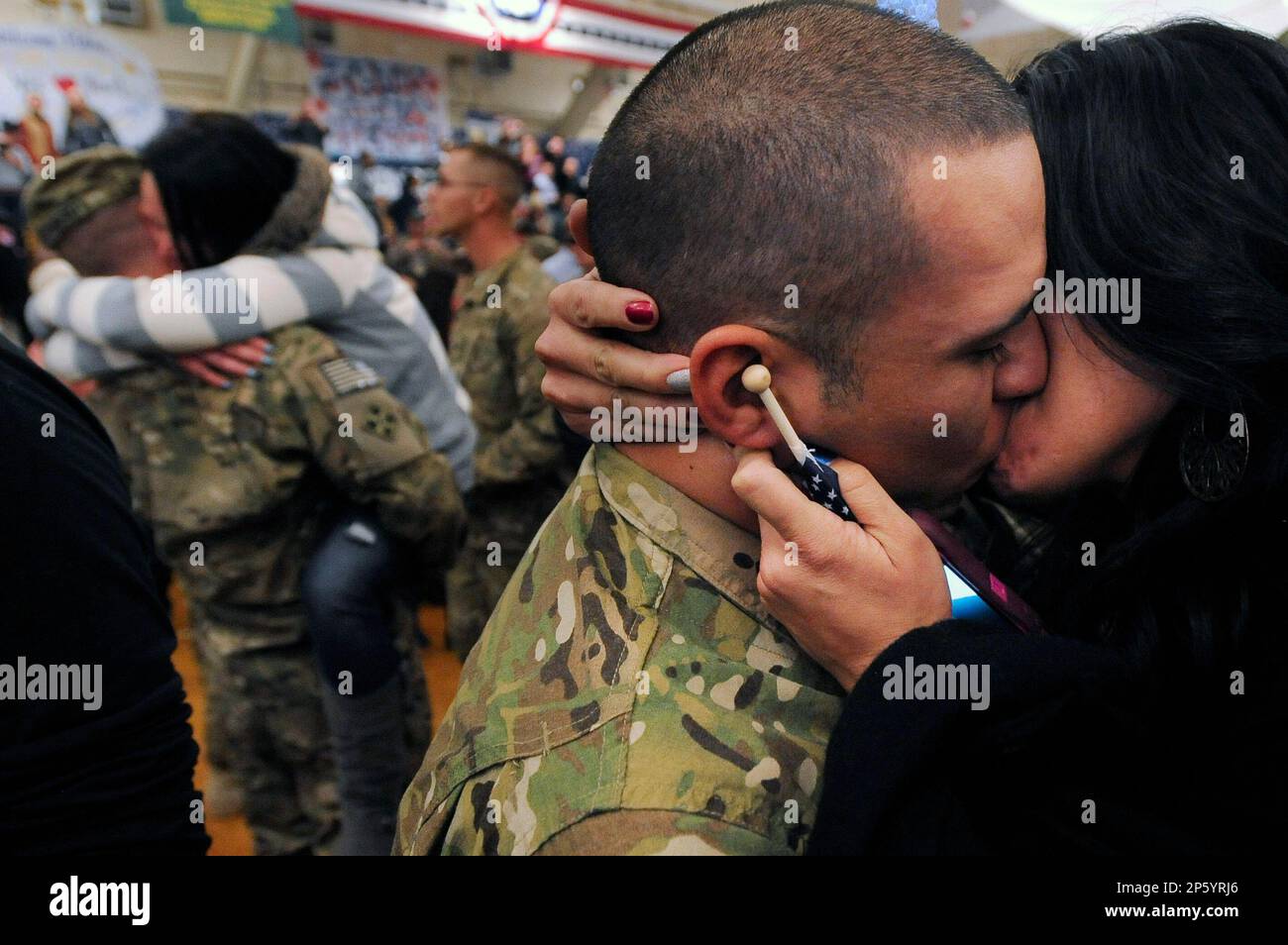 Cassandra Castro, right, kisses her husband, Spc. Phillip Castro during ...