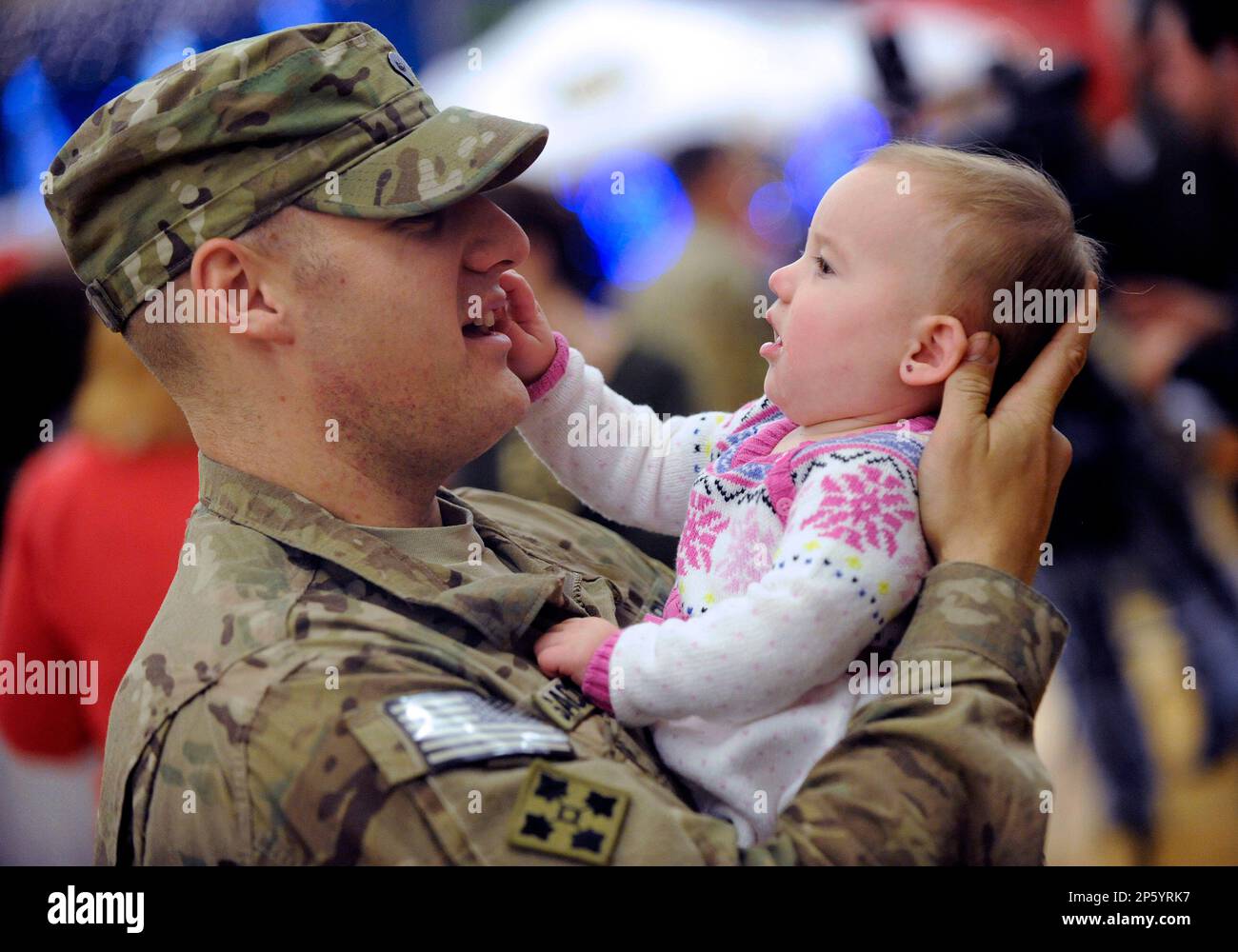 Spc. Michael Saccheri gets acquainted with his nine-month-old daughter ...