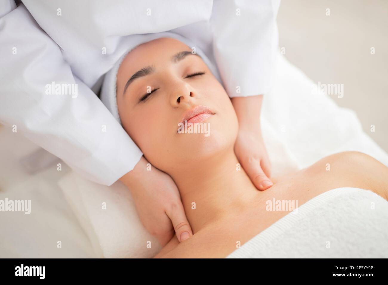 Beautician Doctor Doing Neck Massage To Young Indian Woman In Spa Salon ...