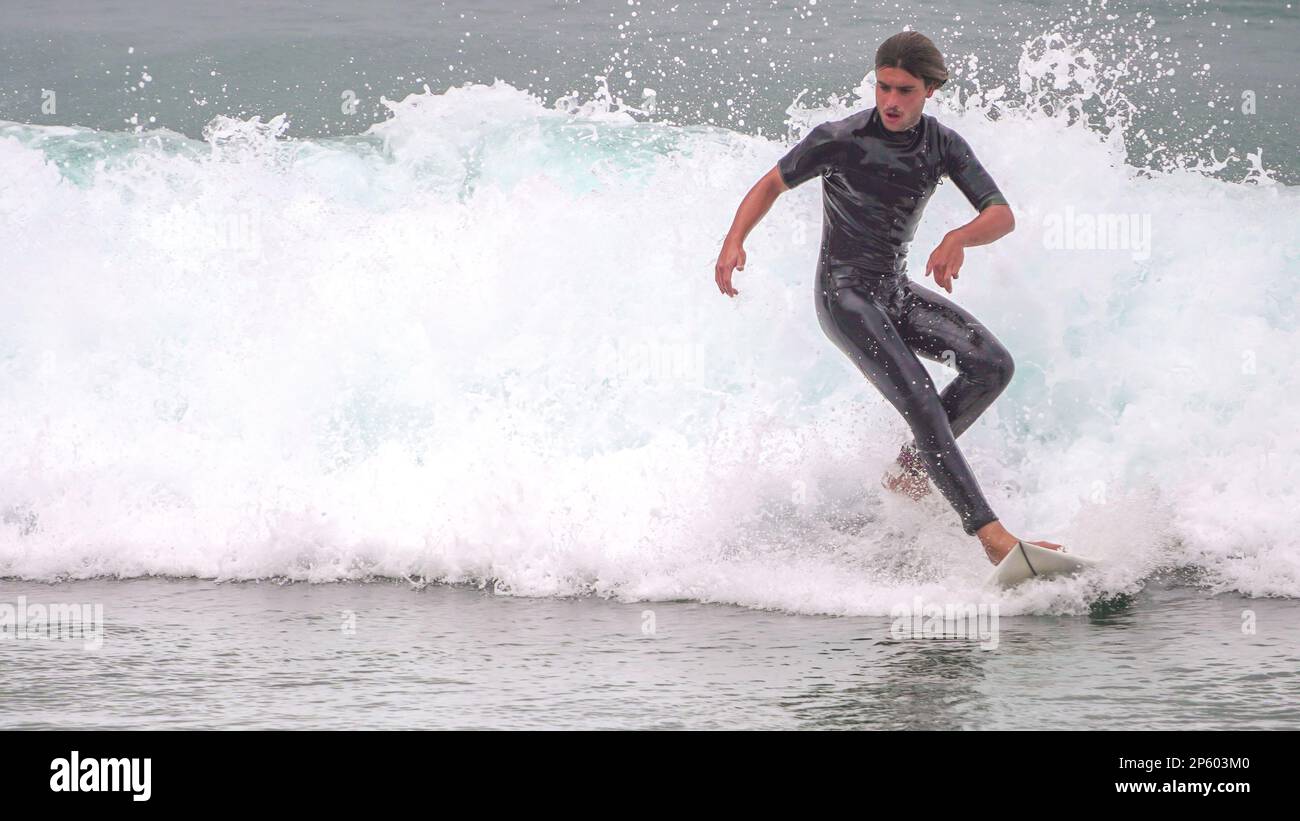 Surfer ride waves in slow motion at Las Canteras beach in Las Palmas de ...