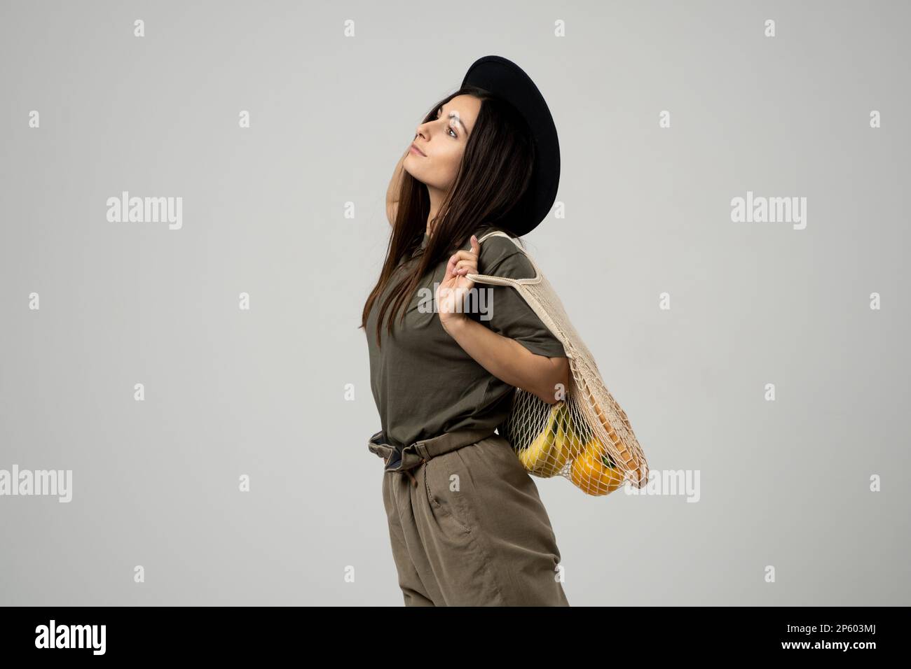 Zero waste concept. A young girl holds on her shoulder a textile mesh ...