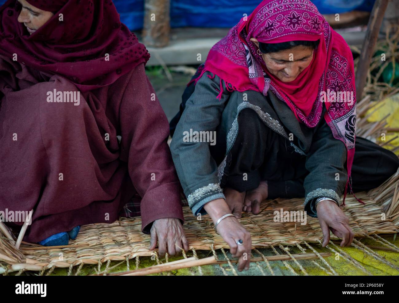 Kashmiri women artisans weave reed and rice straws to create 'Waguv', a ...