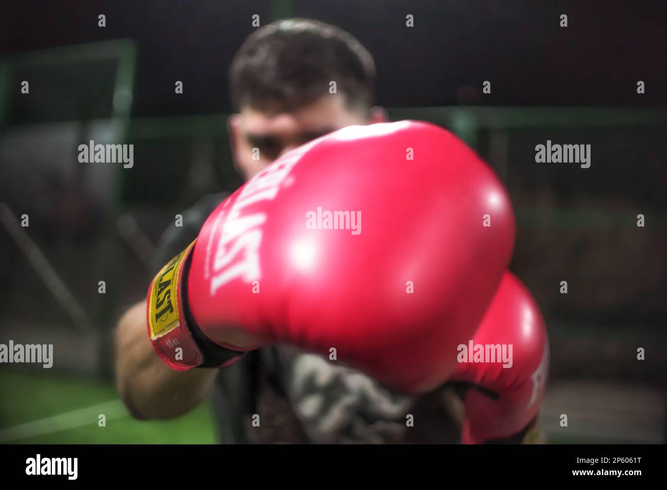 Boxer throwing jabs and punching with boxing gloves at camera in slow ...