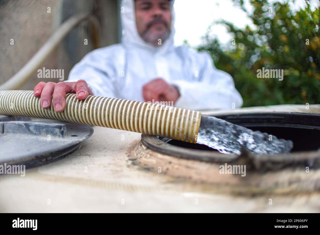 Spray ecological pesticide. Farmer fumigate in protective suit and mask ...