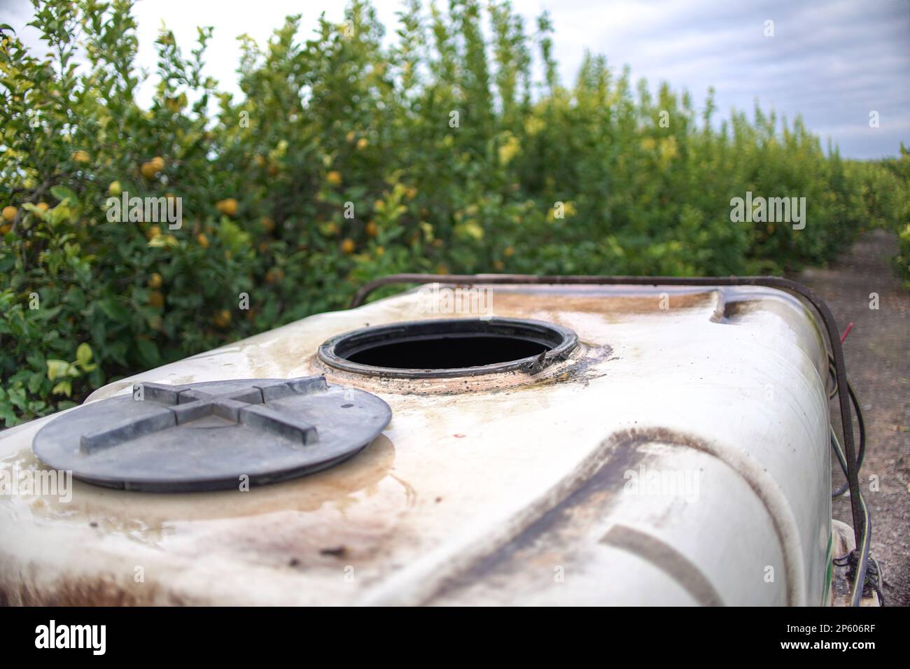 Spray ecological pesticide. Farmer fumigate in protective suit and mask ...