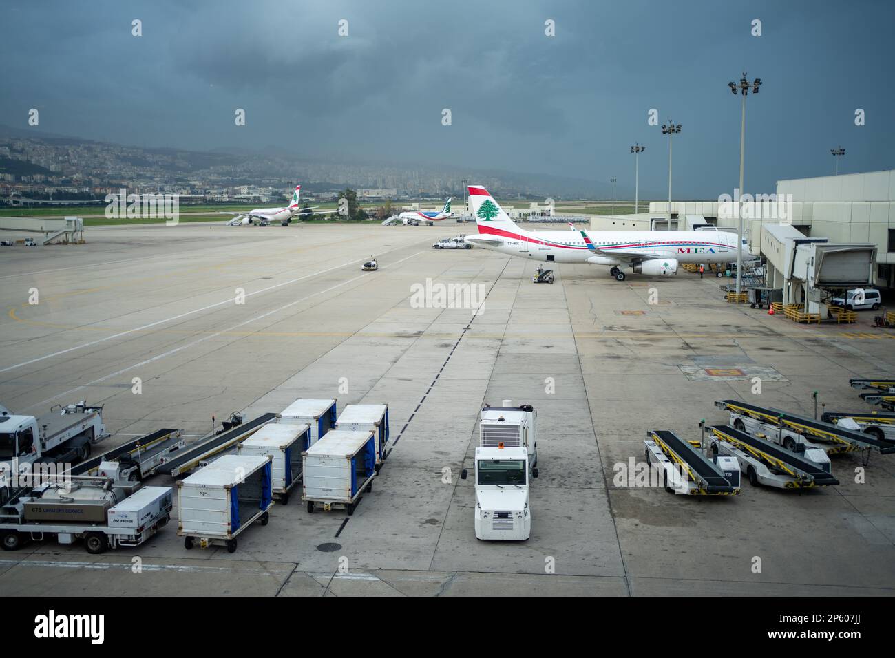 Aerial view of a busy airport tarmac with multiple airplanes parked and ...