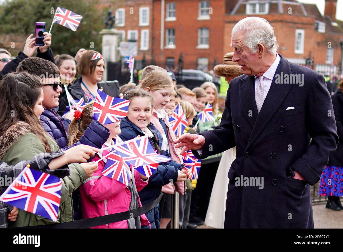 King Charles III speaks with schoolchildren as he arrives for a visit ...