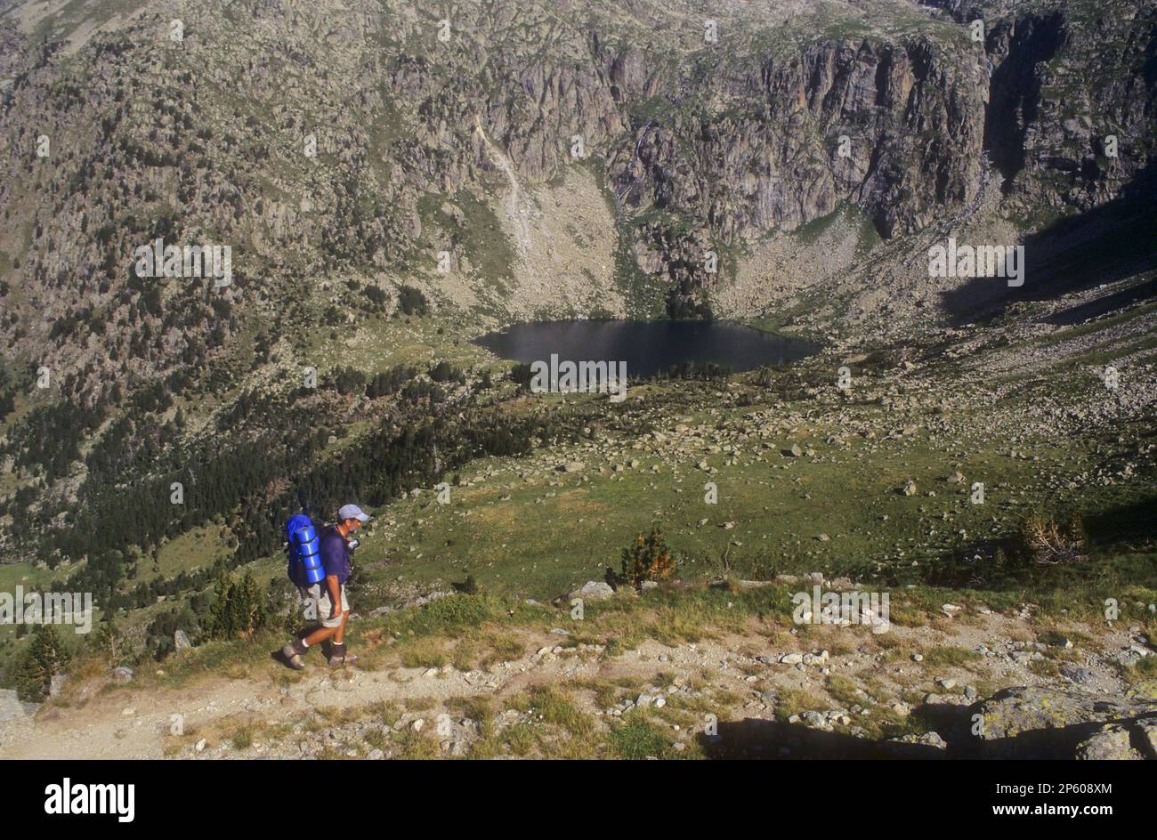 Man climbing to `Portarró d´Espot´ Espot pass, in background `Estany ...