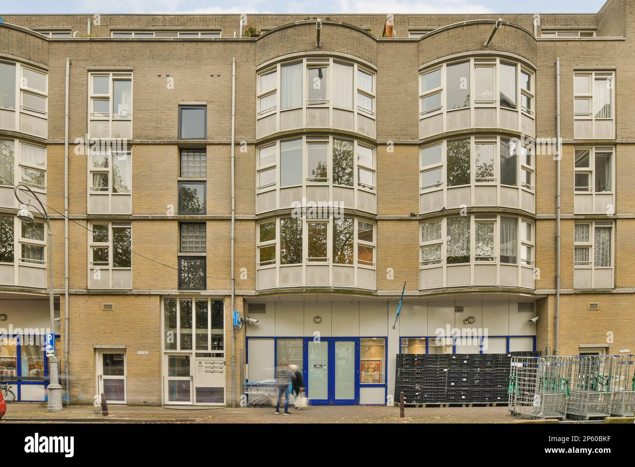 an apartment building with many windows and balks on the front, as seen ...