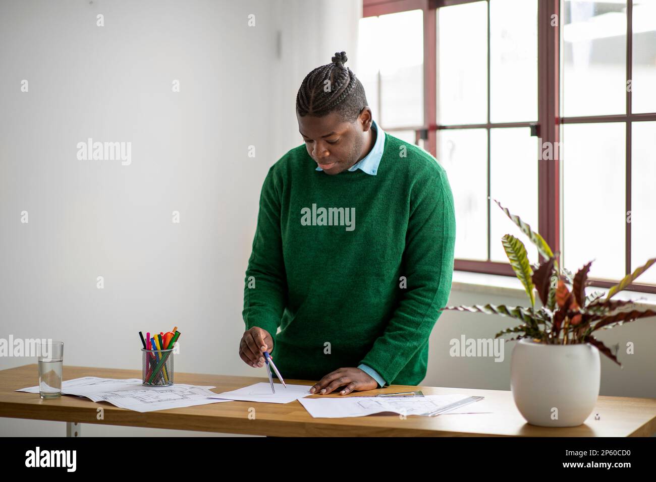African American Guy Making Technical Drawing Using Compass In Office ...