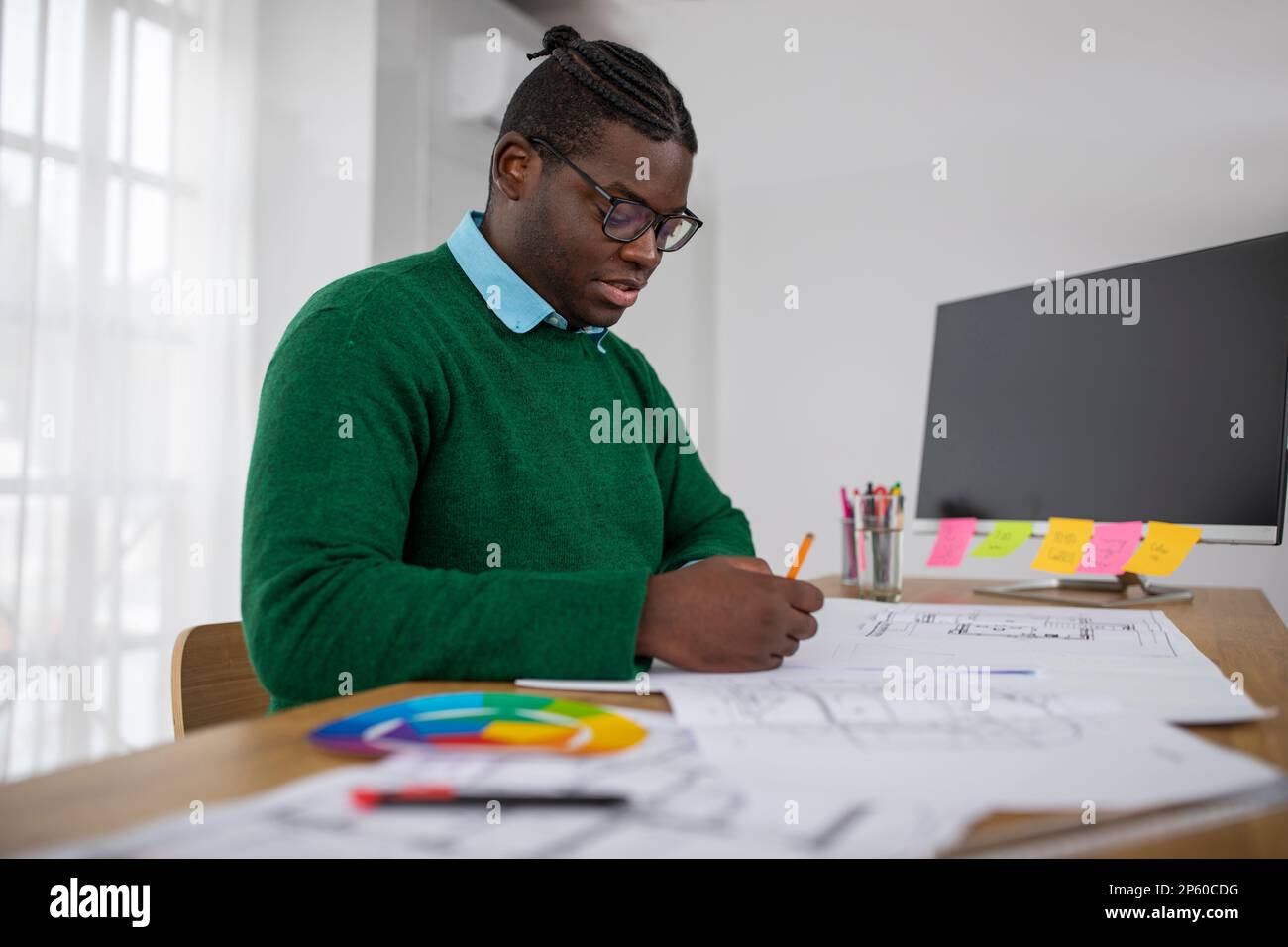 Side View Of Black Designer Man Drawing Sitting In Office Stock Photo ...