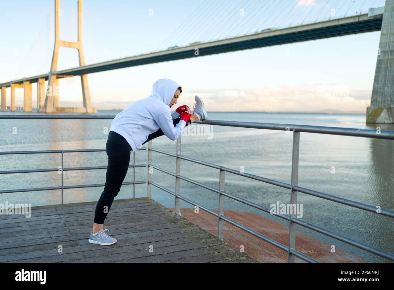 Athlete age woman stretching legs before kickboxing exercises ...