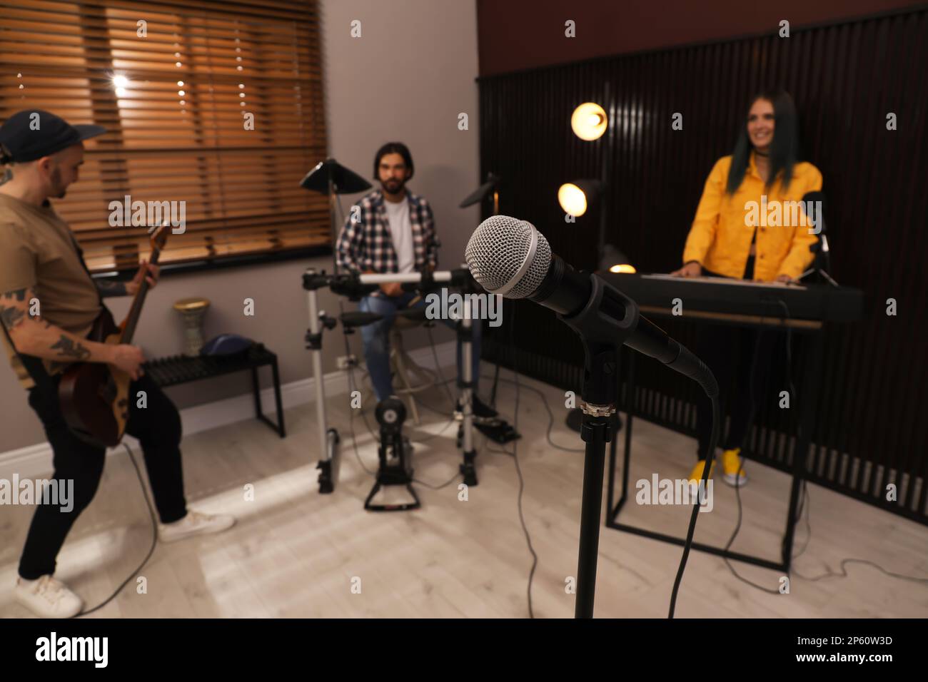 Music band performing in modern recording studio Stock Photo - Alamy
