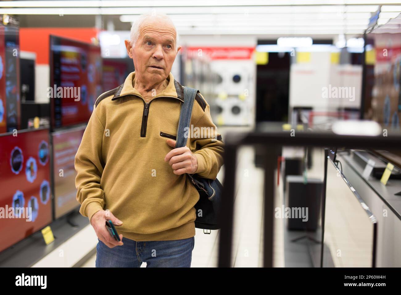 senor man pensioner buying modern digital televisor with smart tv in ...