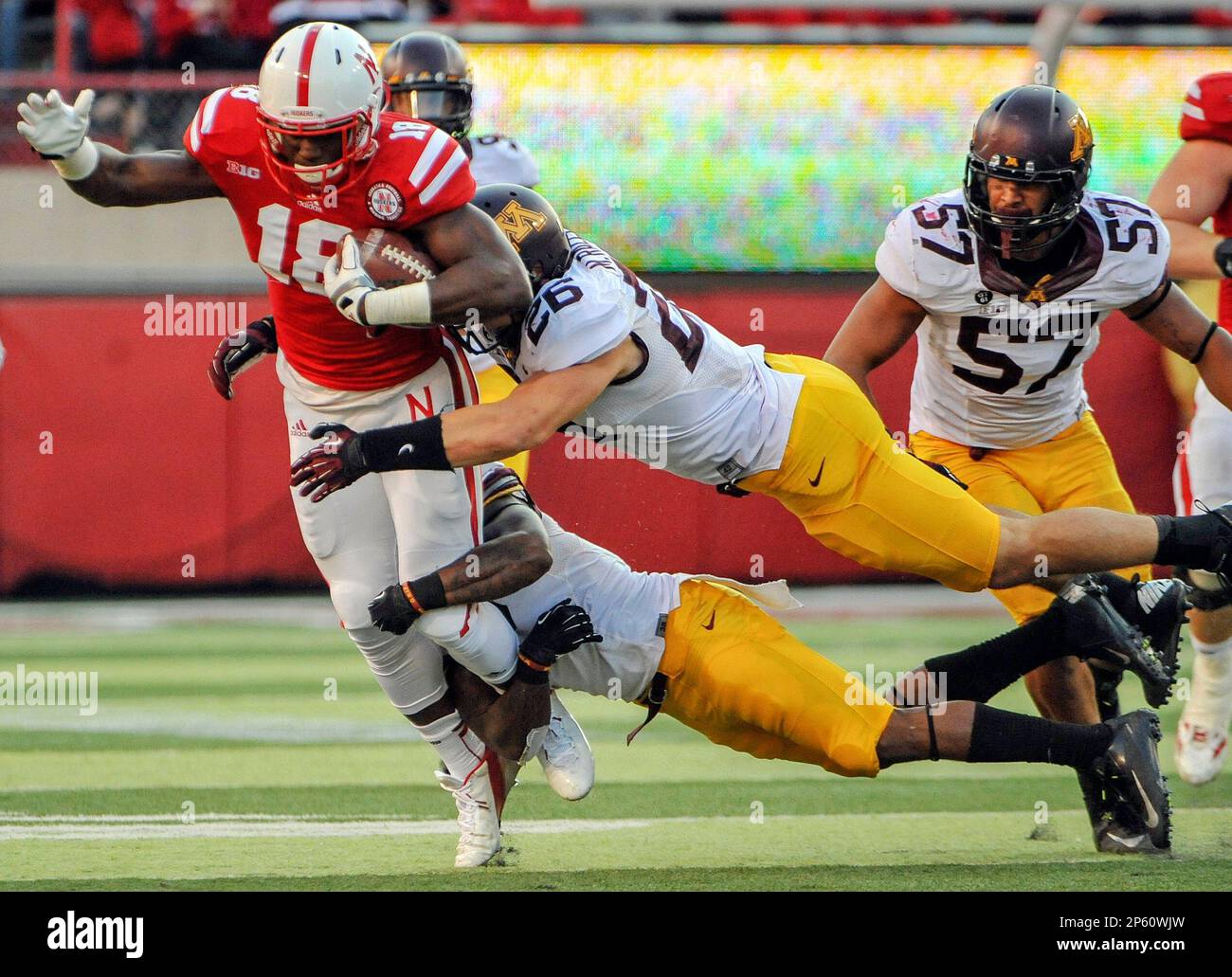 Minnesota's Troy Stoudermire, bottom, and Mike Rallis (26) tackle ...