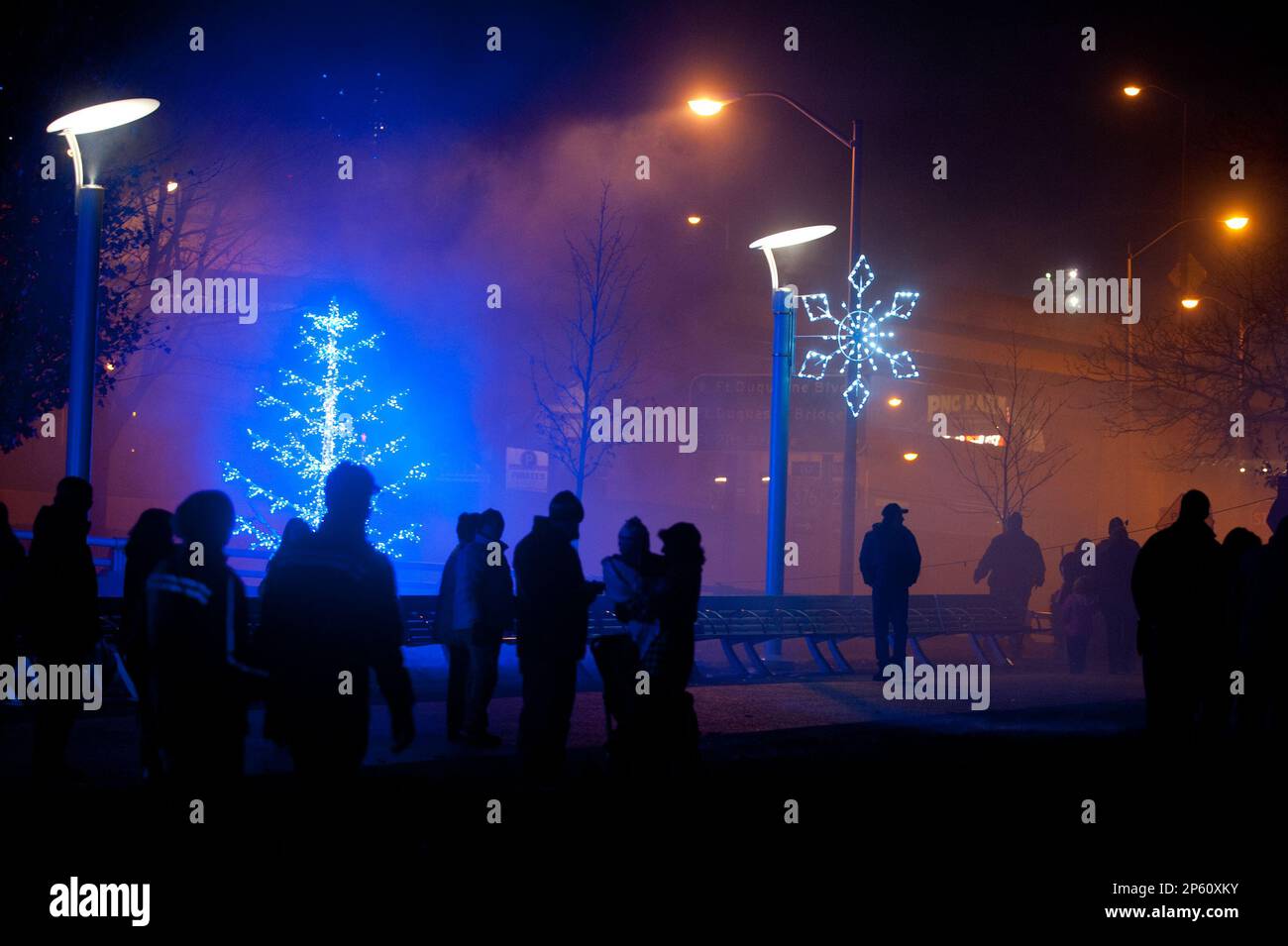 Smoke from celebratory fireworks silhouettes the crowd at Point State ...
