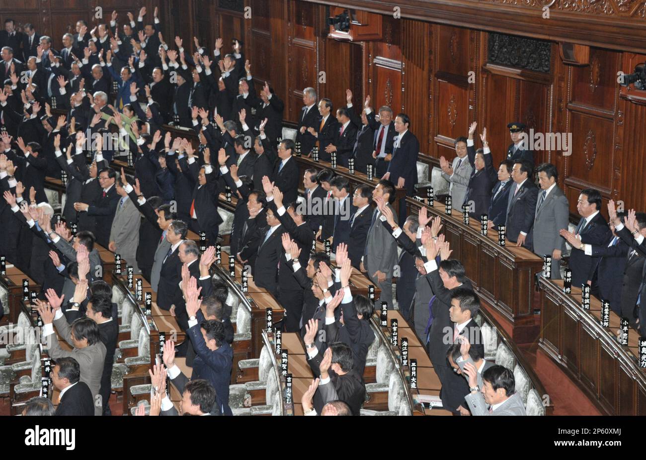 Lawmakers at the House of Representatives give a banzai cheer after the ...