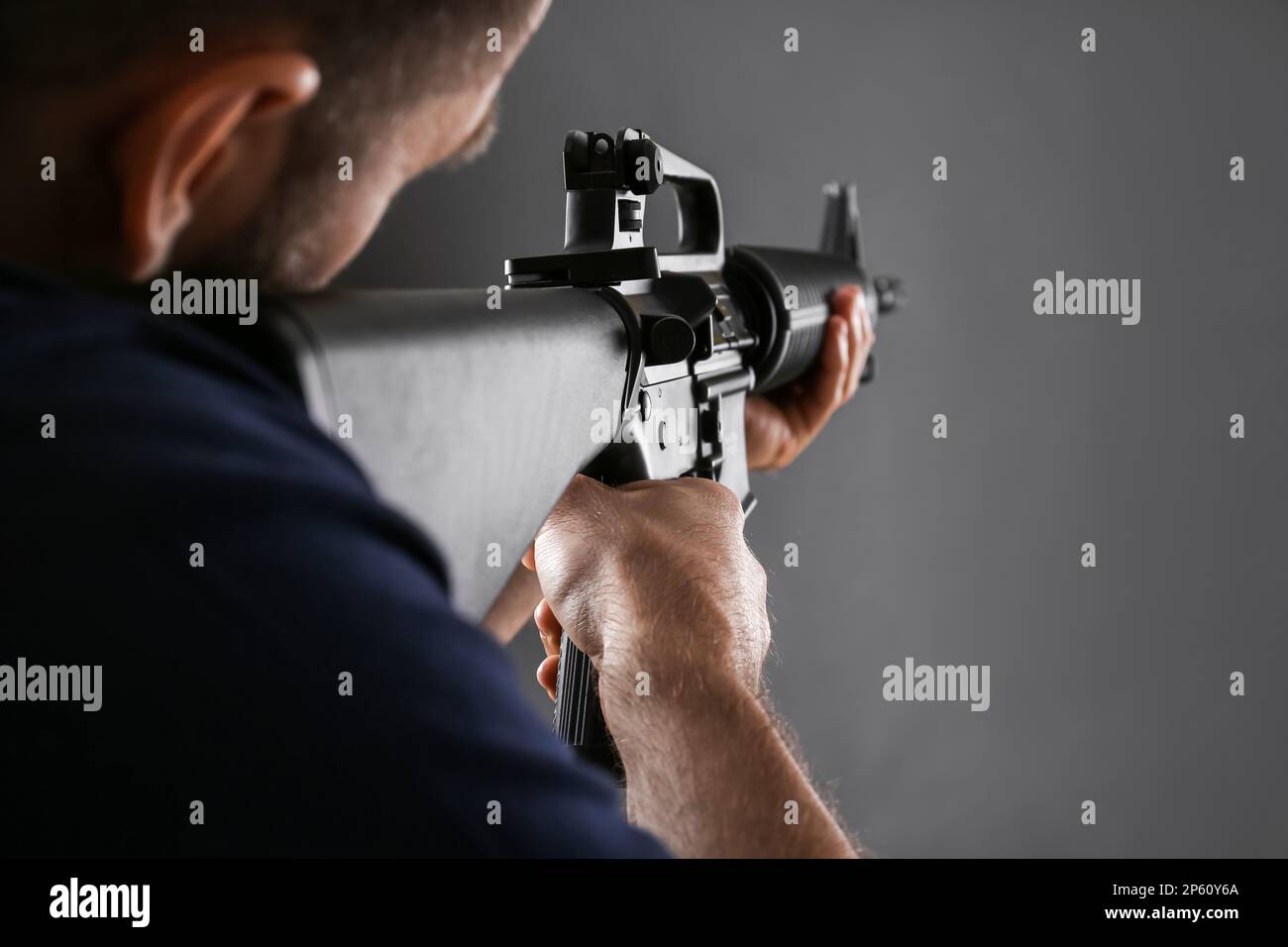 Assault gun. Man aiming rifle on dark background, closeup Stock Photo ...