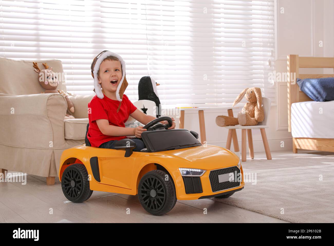 Little child playing with toy car in room Stock Photo - Alamy