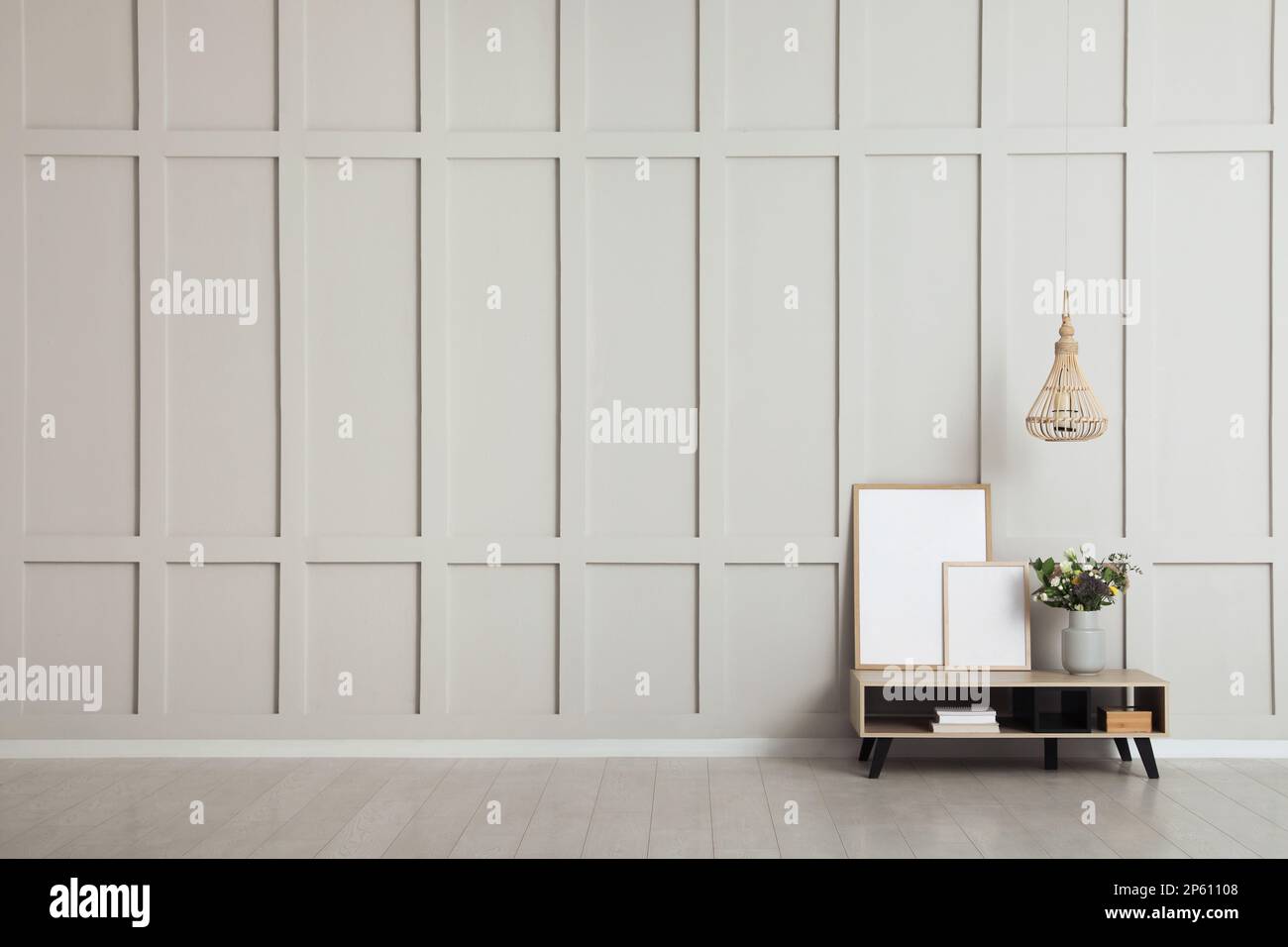 Simple room interior with console table, decor elements and empty wall ...
