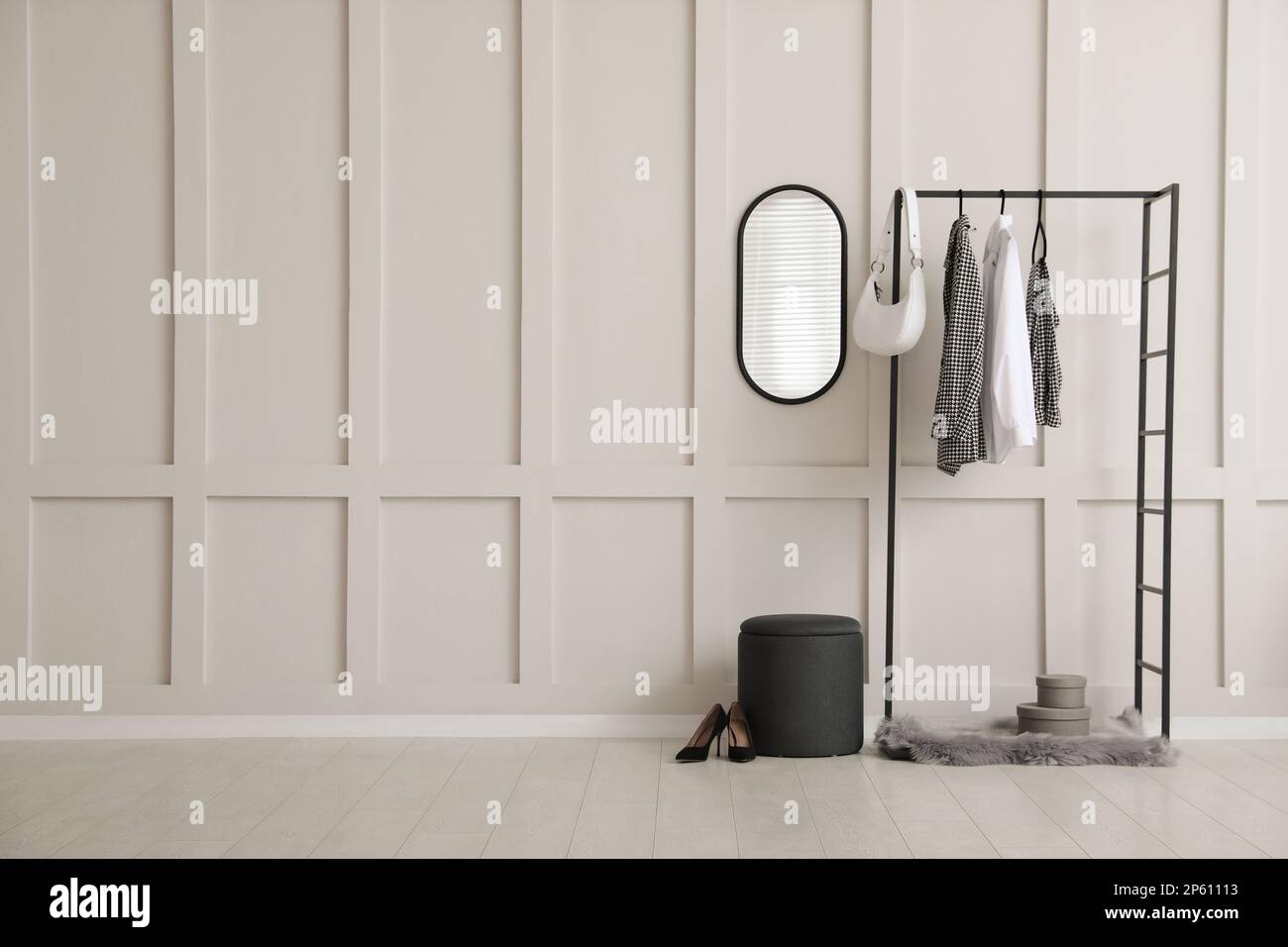 Simple hallway interior with clothing rack, mirror and empty wall ...