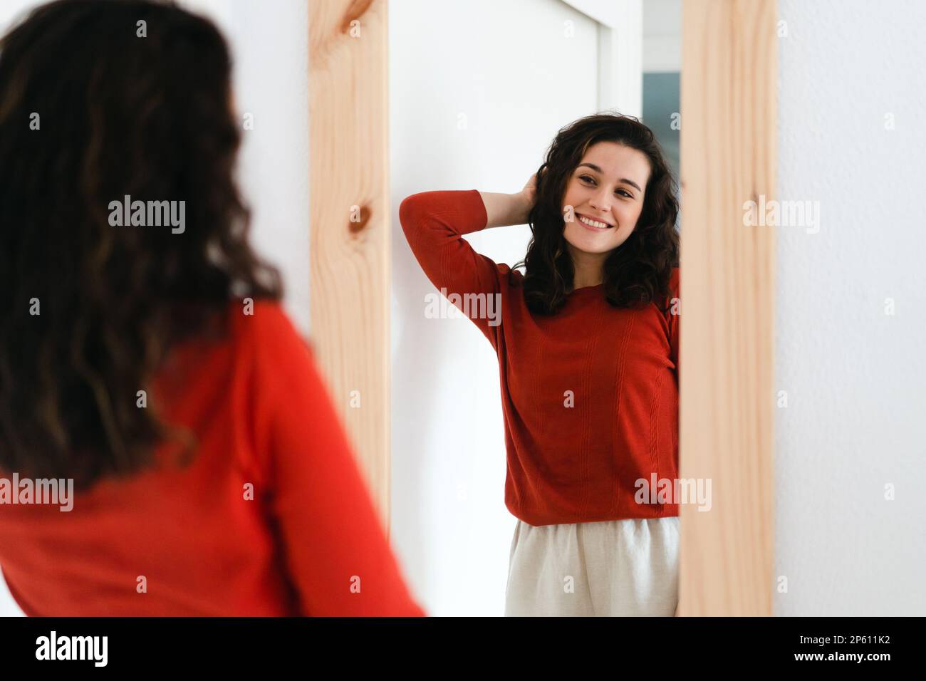 Young beautiful self confident woman in red sweater looking in the ...