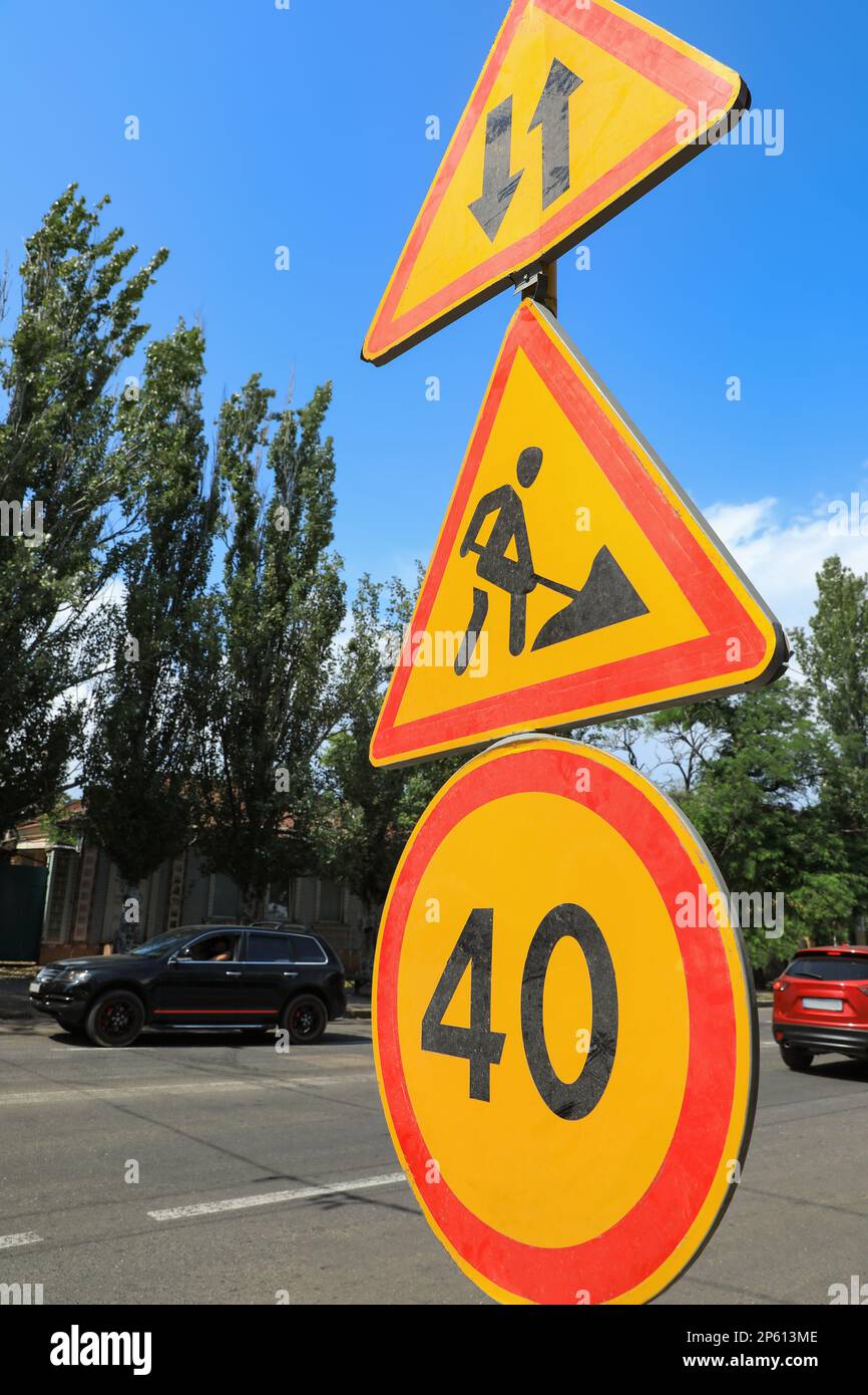 Traffic signs on city street. Road repair Stock Photo - Alamy