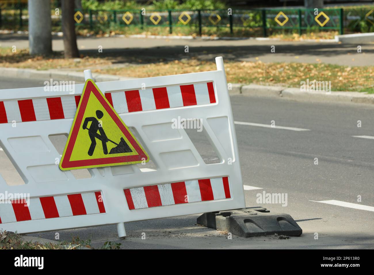 Barricade with road construction sign on city street. Repair works ...