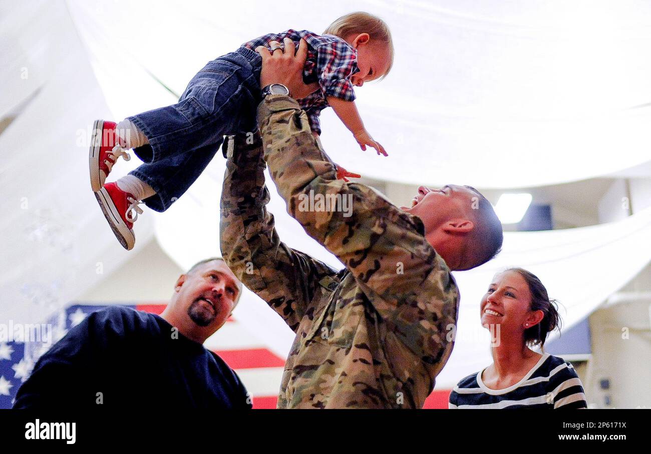 Sgt. Neil Casey reunites with and lifts up his one-year-old son Aiden ...