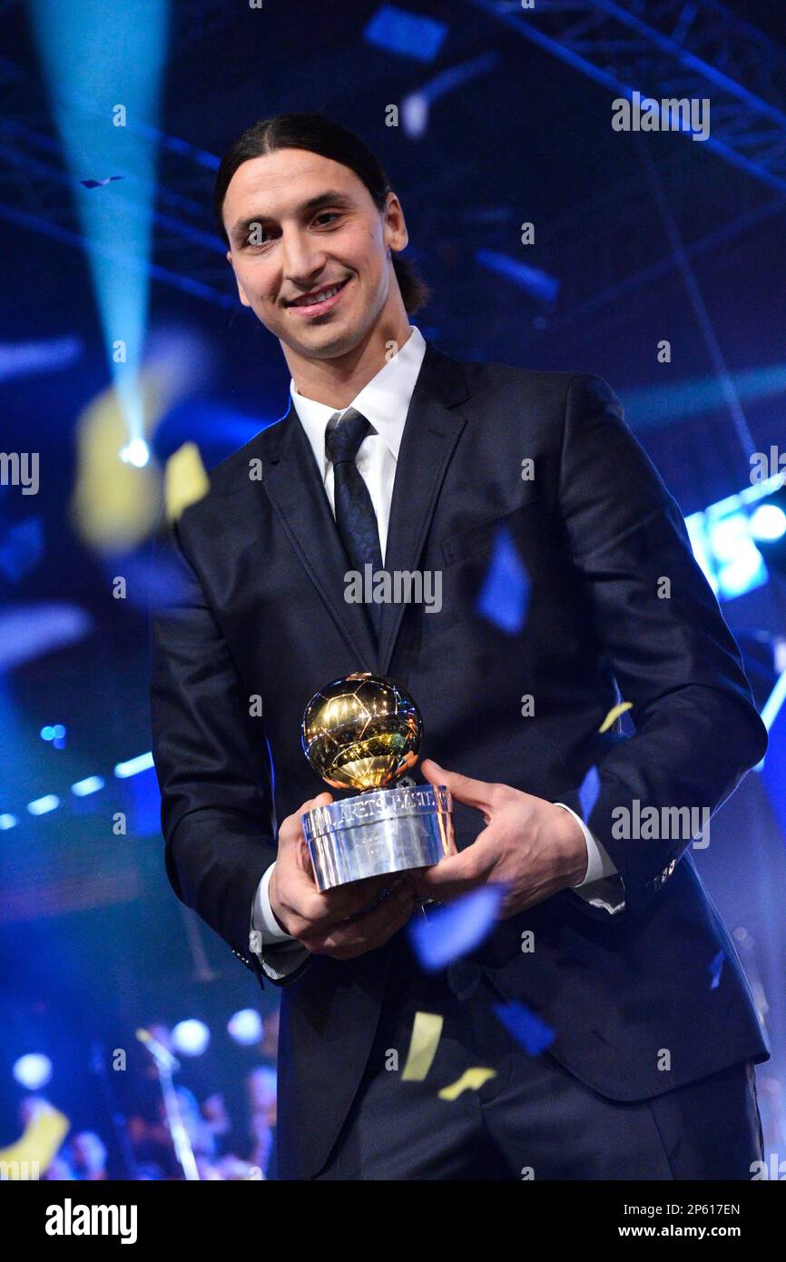 Swedish soccer player Zlatan Ibrahimovic holds the trophy after being ...