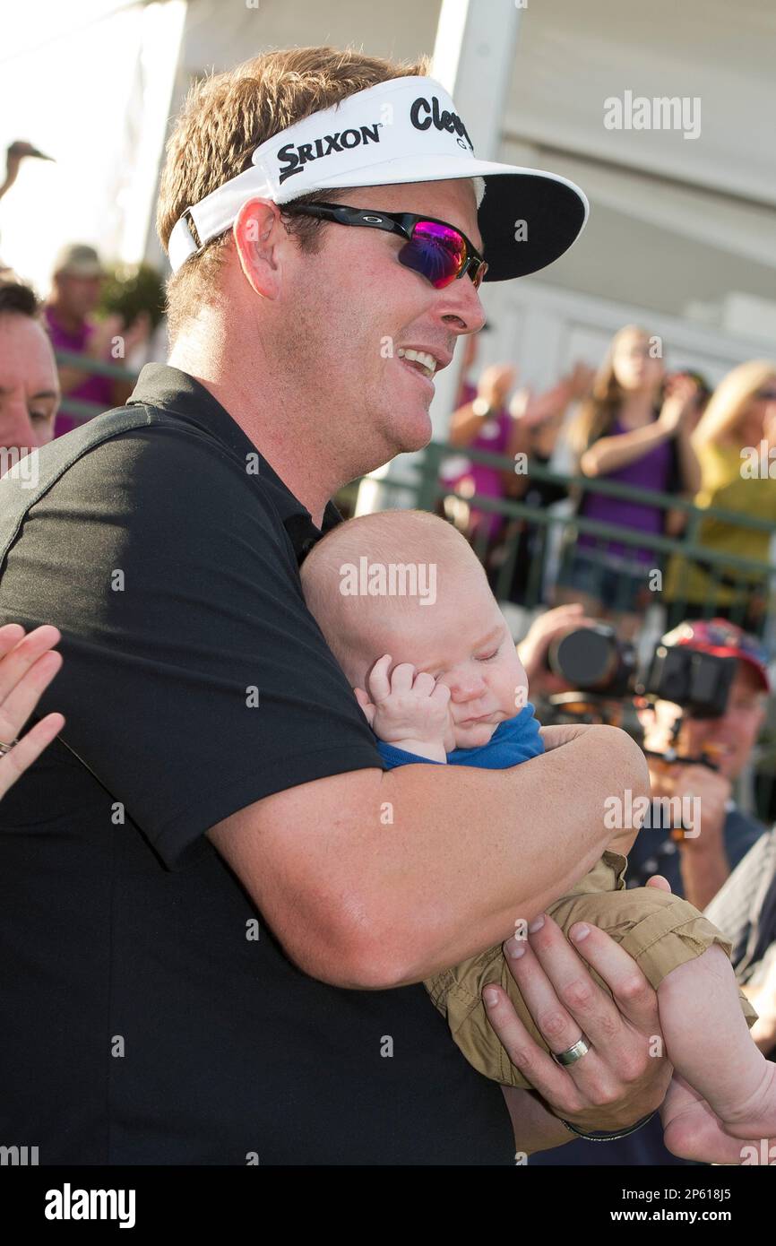 November 11, 2012: Charlie Beljan holds his son Graham after winning ...