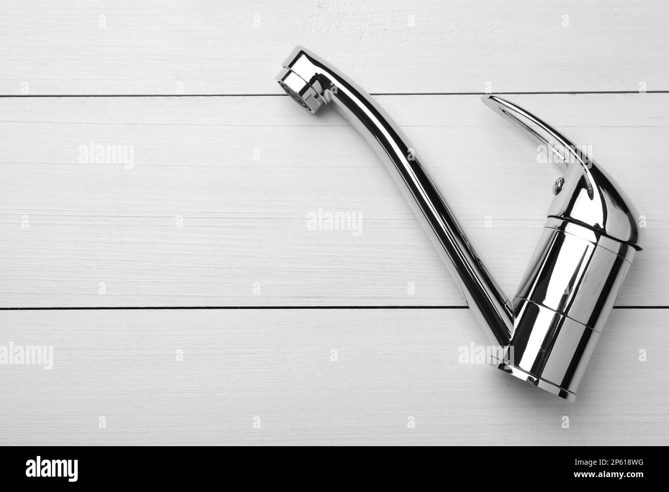 Single handle water tap on white wooden table, top view. Space for text ...