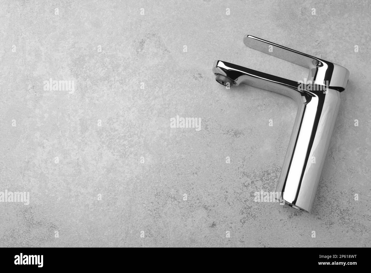 Single handle water tap on grey table, top view. Space for text Stock ...