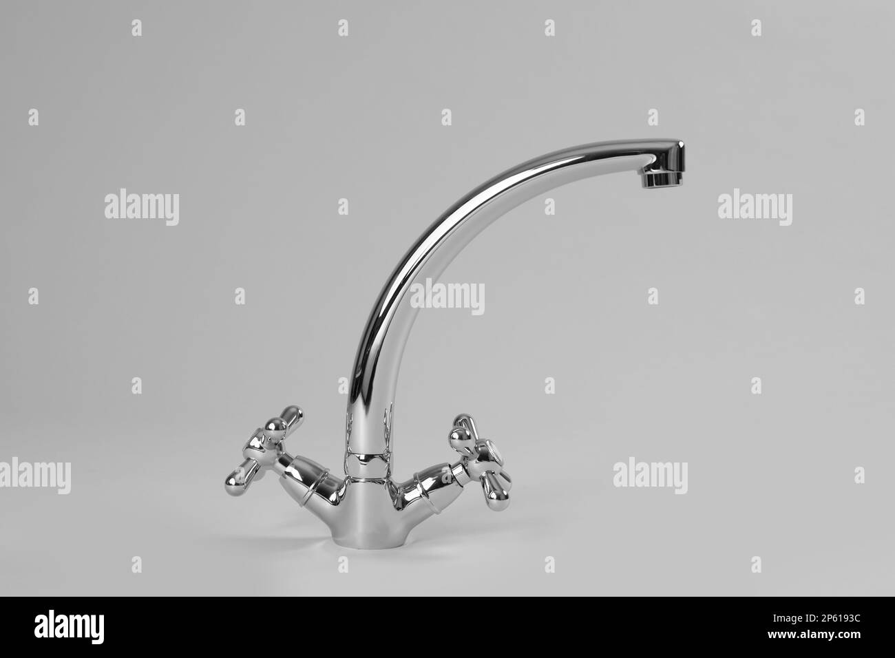 Double handle water tap on grey background Stock Photo - Alamy