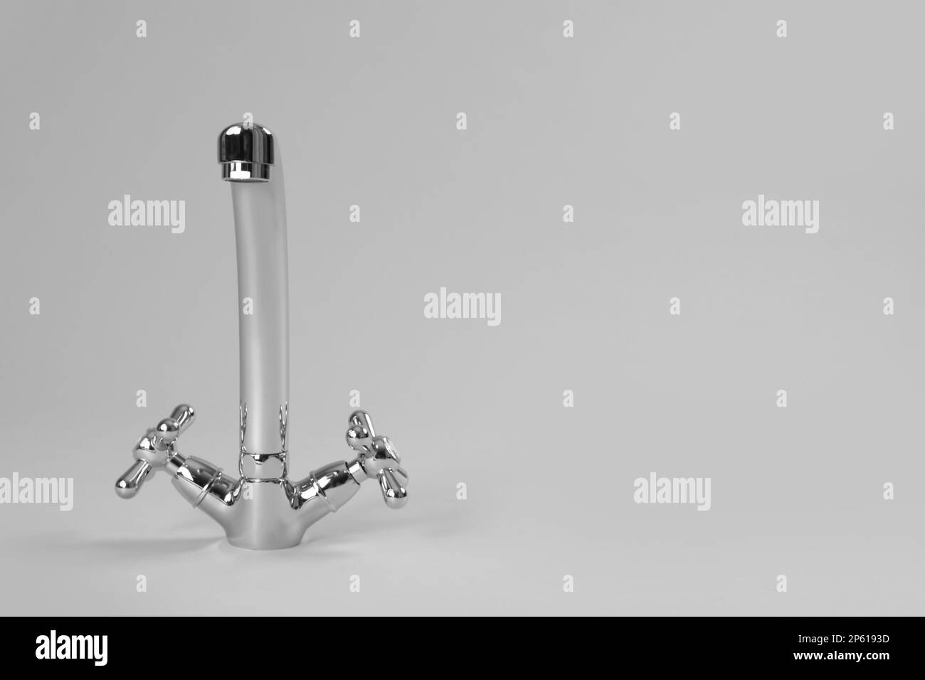 Double handle water tap on grey background. Space for text Stock Photo ...