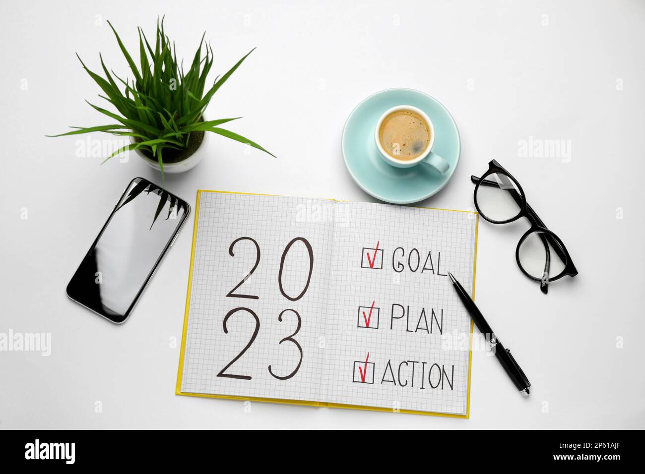 Flat lay composition of notebook with text 2023 Goal, Plan, Action on white background. New year ...
