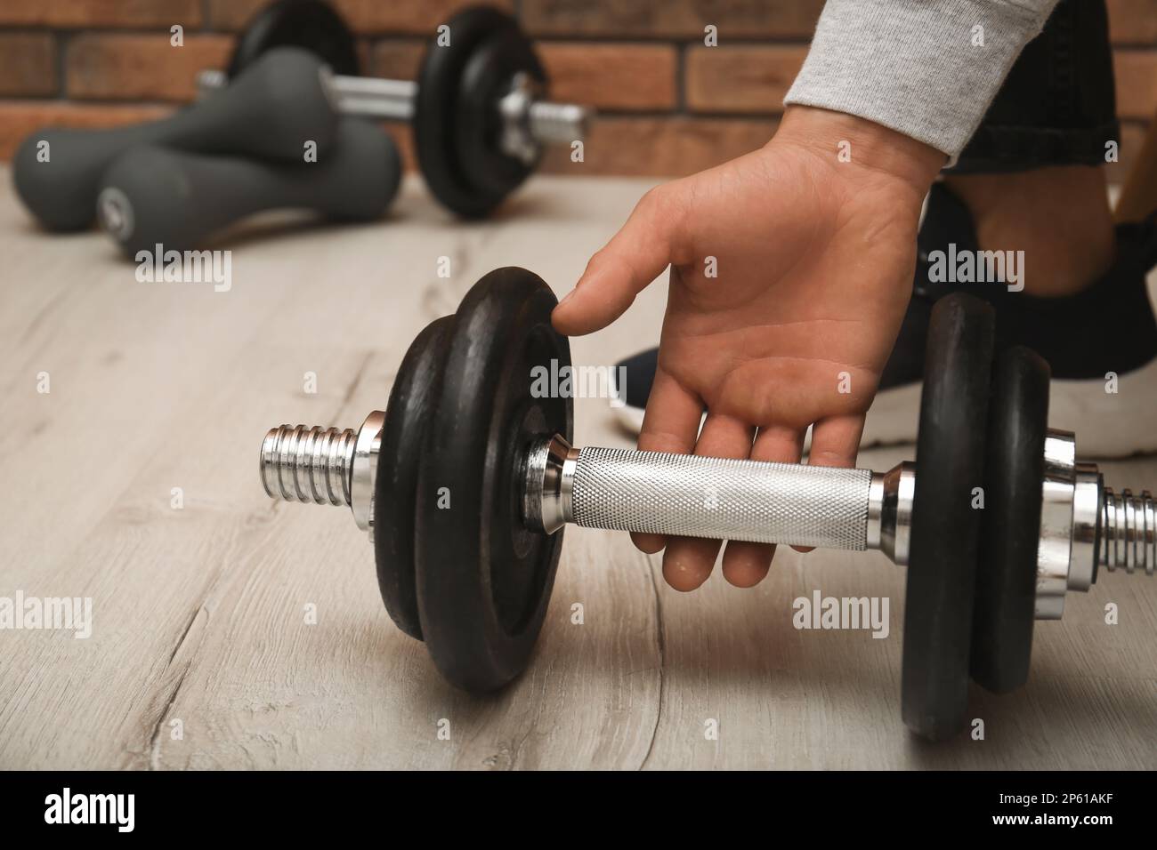 Athlete taking dumbbell indoors, closeup. Suffering from calluses on ...