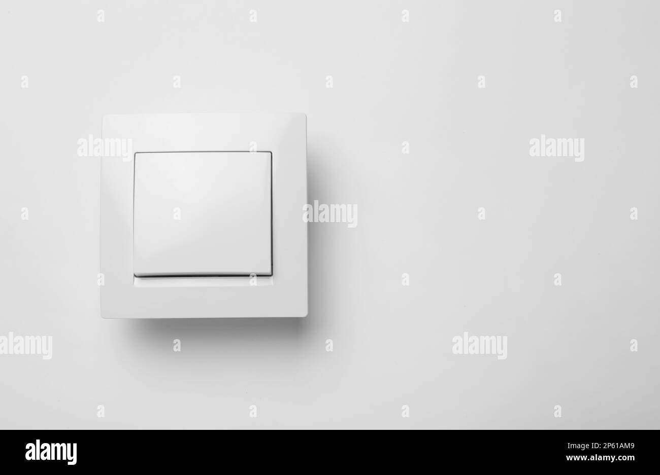 Modern plastic light switch on white background. Space for text Stock ...