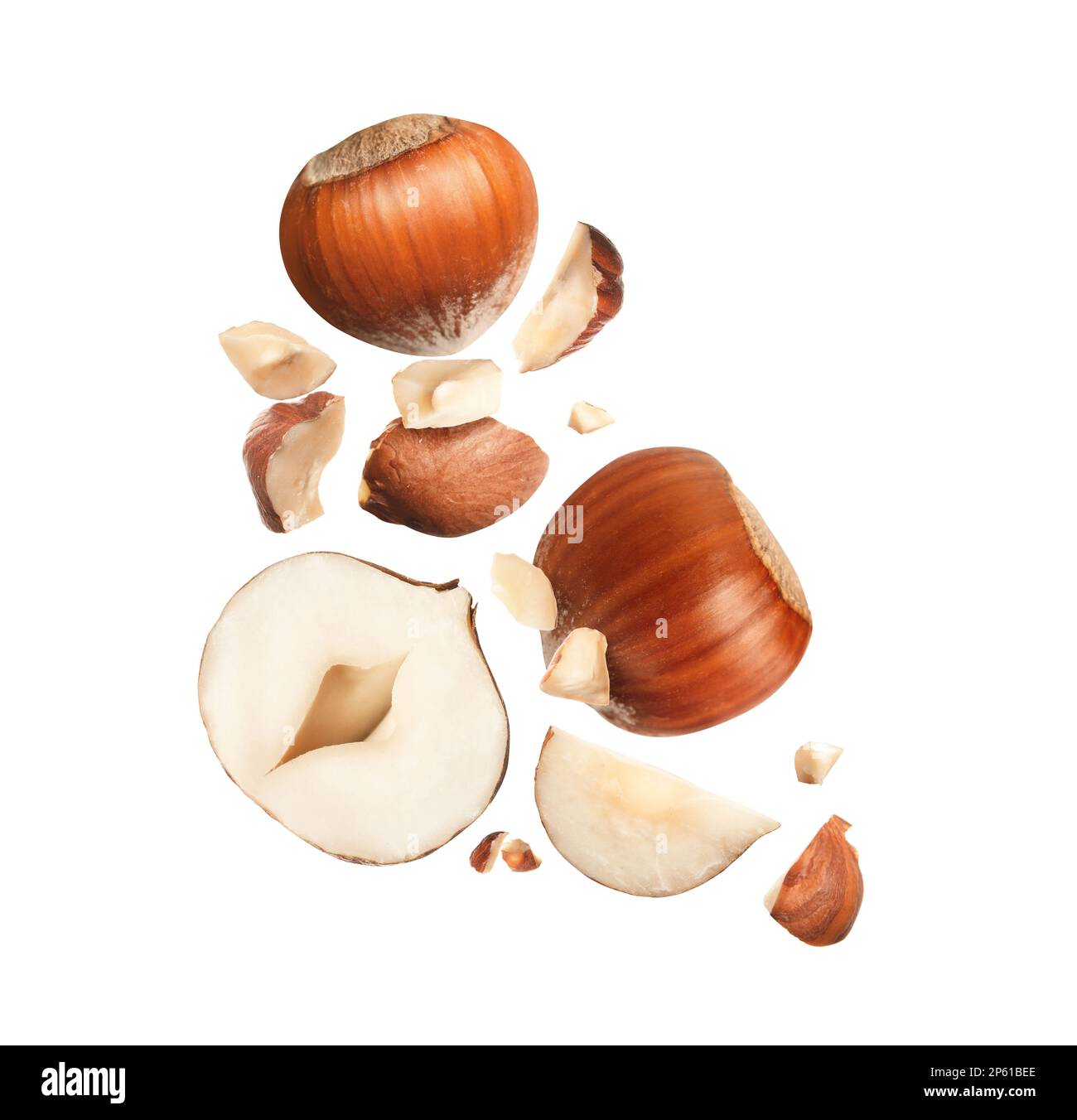 Pieces of tasty hazelnuts falling on white background Stock Photo - Alamy