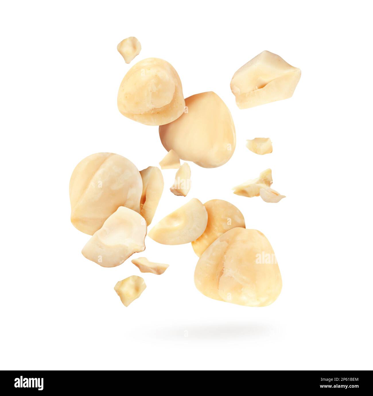 Pieces of tasty hazelnuts falling on white background Stock Photo - Alamy