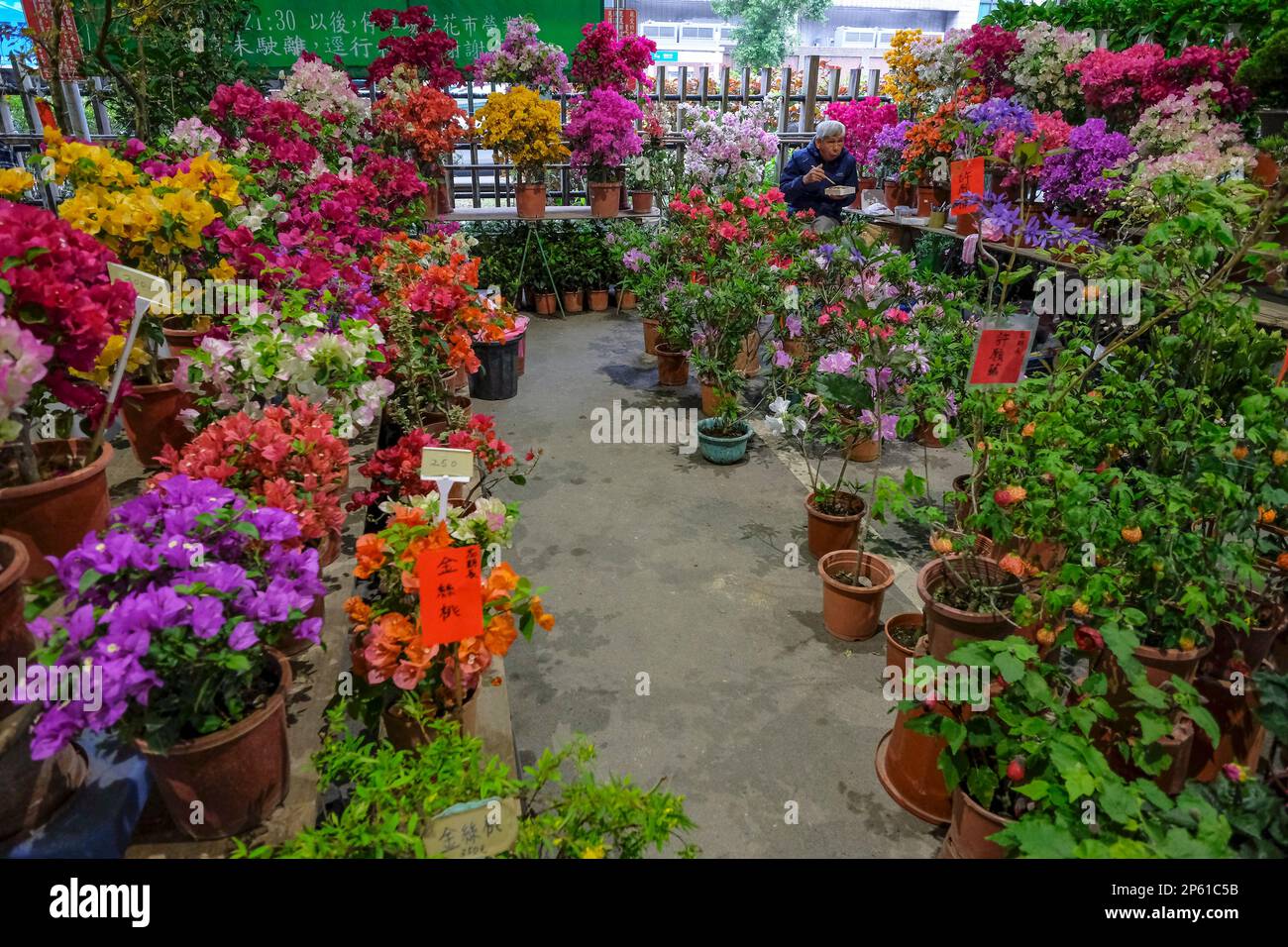 Taipei, Taiwan - February 25, 2023: A man eating at a stall at the ...